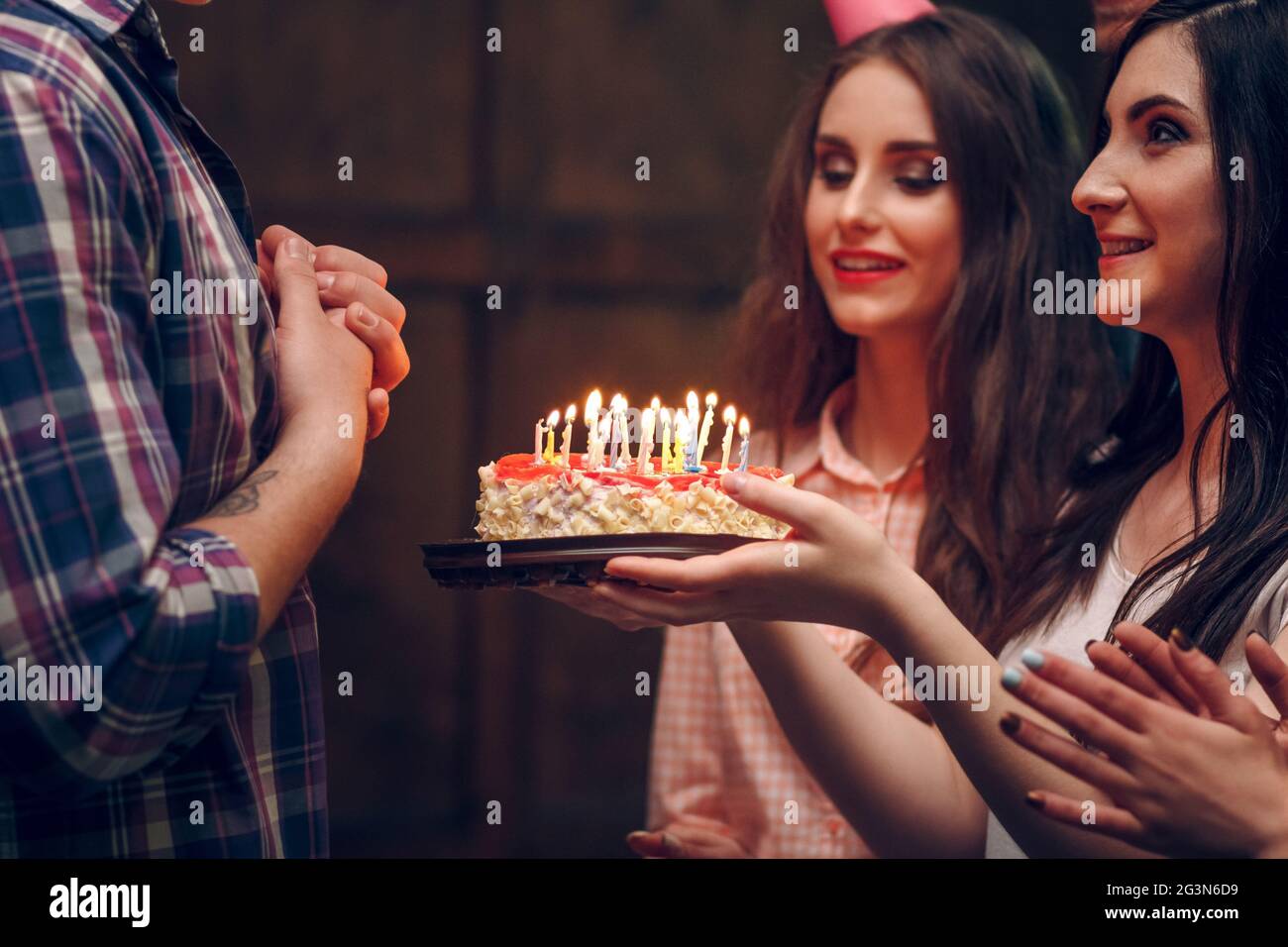 Young woman giving birthday cake Stock Photo - Alamy