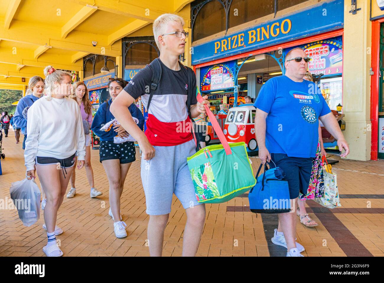 Crowds enjoying a sunny summer’s day walk along Barry Island promenade ...