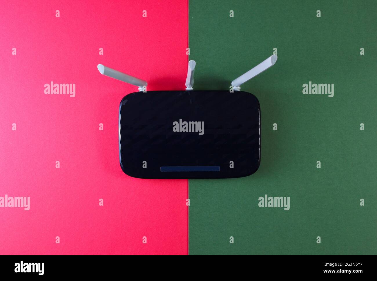 Tried Wi fi router on red green background. Top view Stock Photo - Alamy