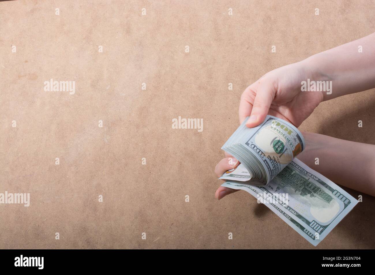 Hand holding American dollar isolated on wooden background Stock Photo ...