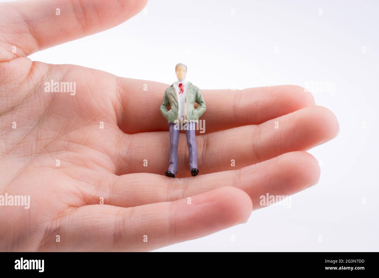 Hand holding a figure Stock Photo - Alamy