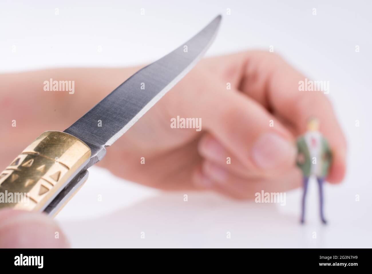 Hand holding a pocket knife near a figure Stock Photo - Alamy