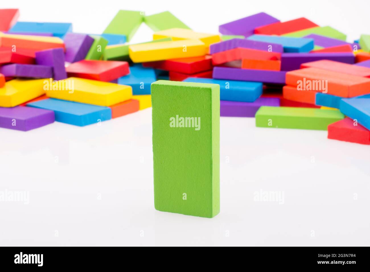 Hand playing with colored domino Stock Photo - Alamy