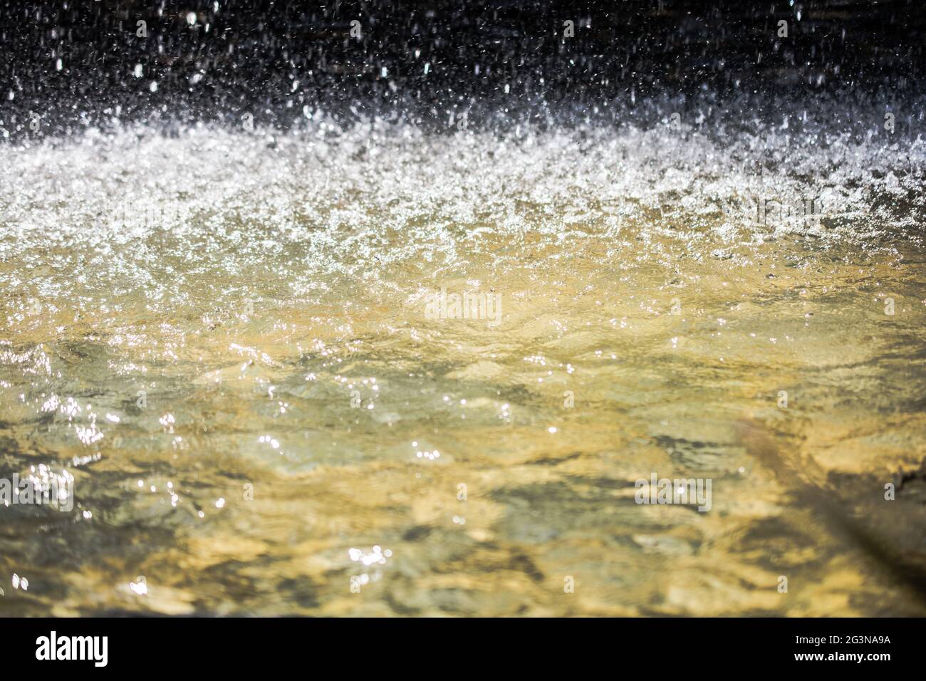 Small waterfall pouring into a small lake Stock Photo - Alamy