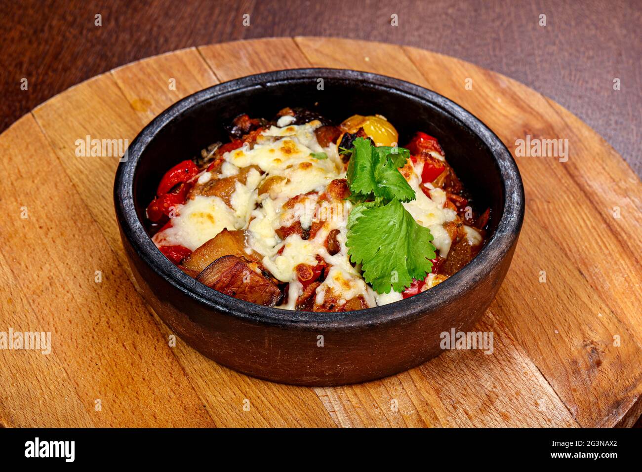 Roasted Pork and vegetables with cheese in the pot Stock Photo - Alamy
