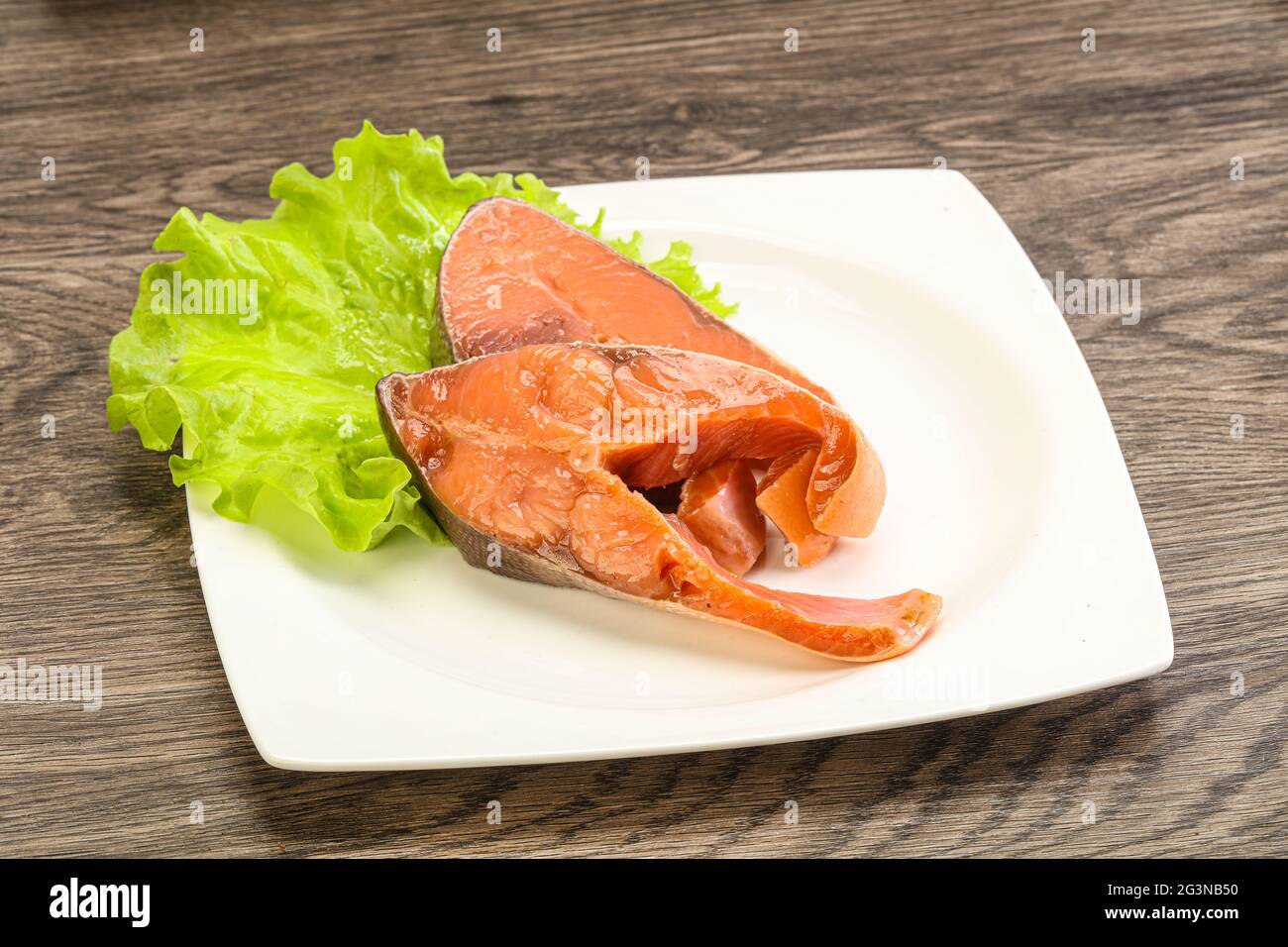 Two pink salmon fish steak served salad leaves Stock Photo - Alamy