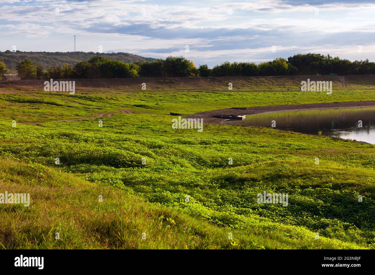Rustic riverside landscape . Green river bank scenery Stock Photo - Alamy