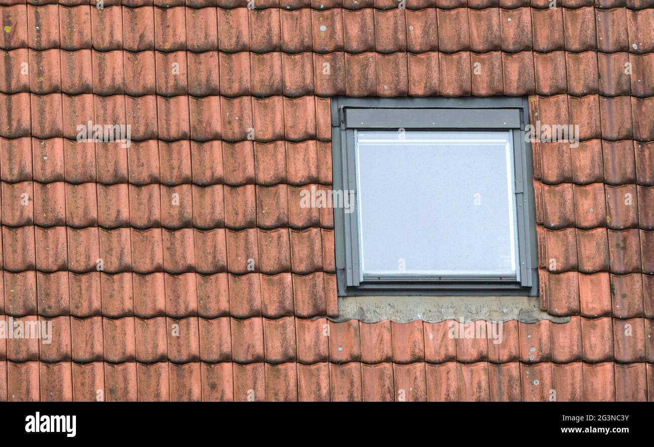 Window installed in red roof background Stock Photo - Alamy
