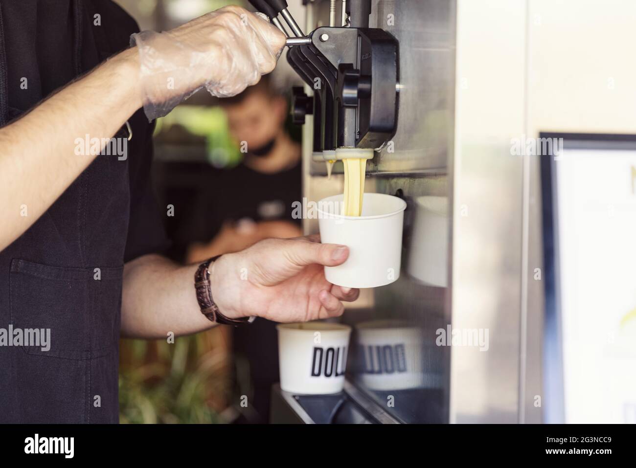 Human hand holding cone with twisted ice cream from machine Stock Photo ...