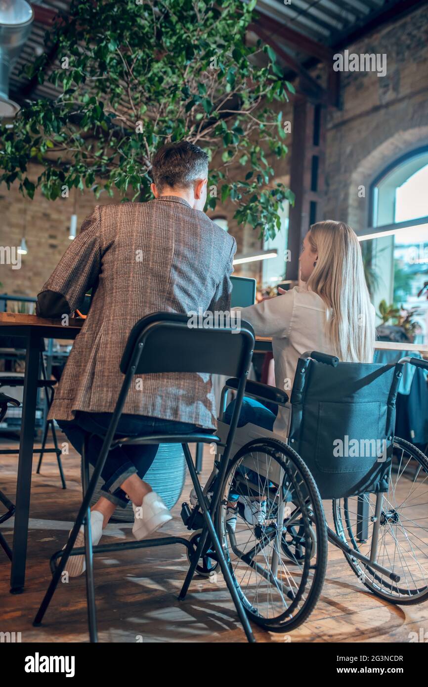 Back view woman in wheelchair hi-res stock photography and images - Alamy