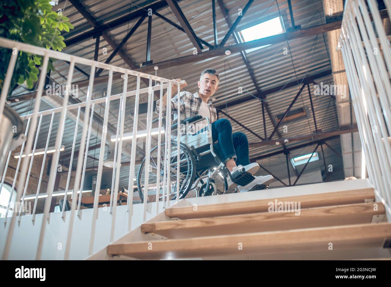 Man in wheelchair looking down stairs in horror Stock Photo - Alamy