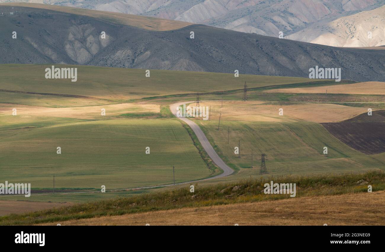 Country road between farm fields Stock Photo - Alamy