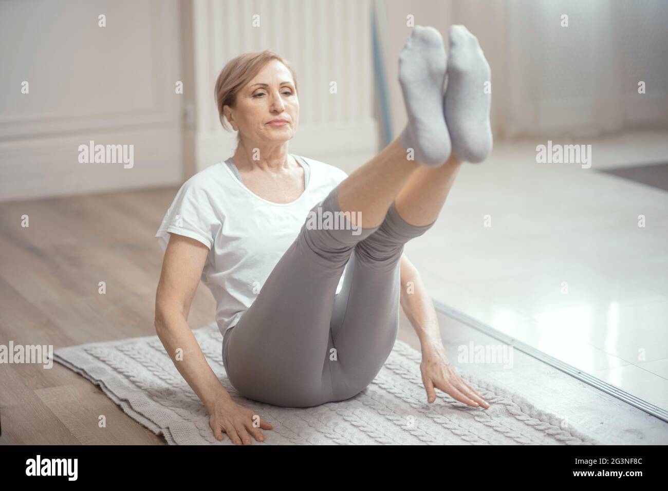 European Looking Woman Over 50 Years Old Doing Yoga at Home in the ...