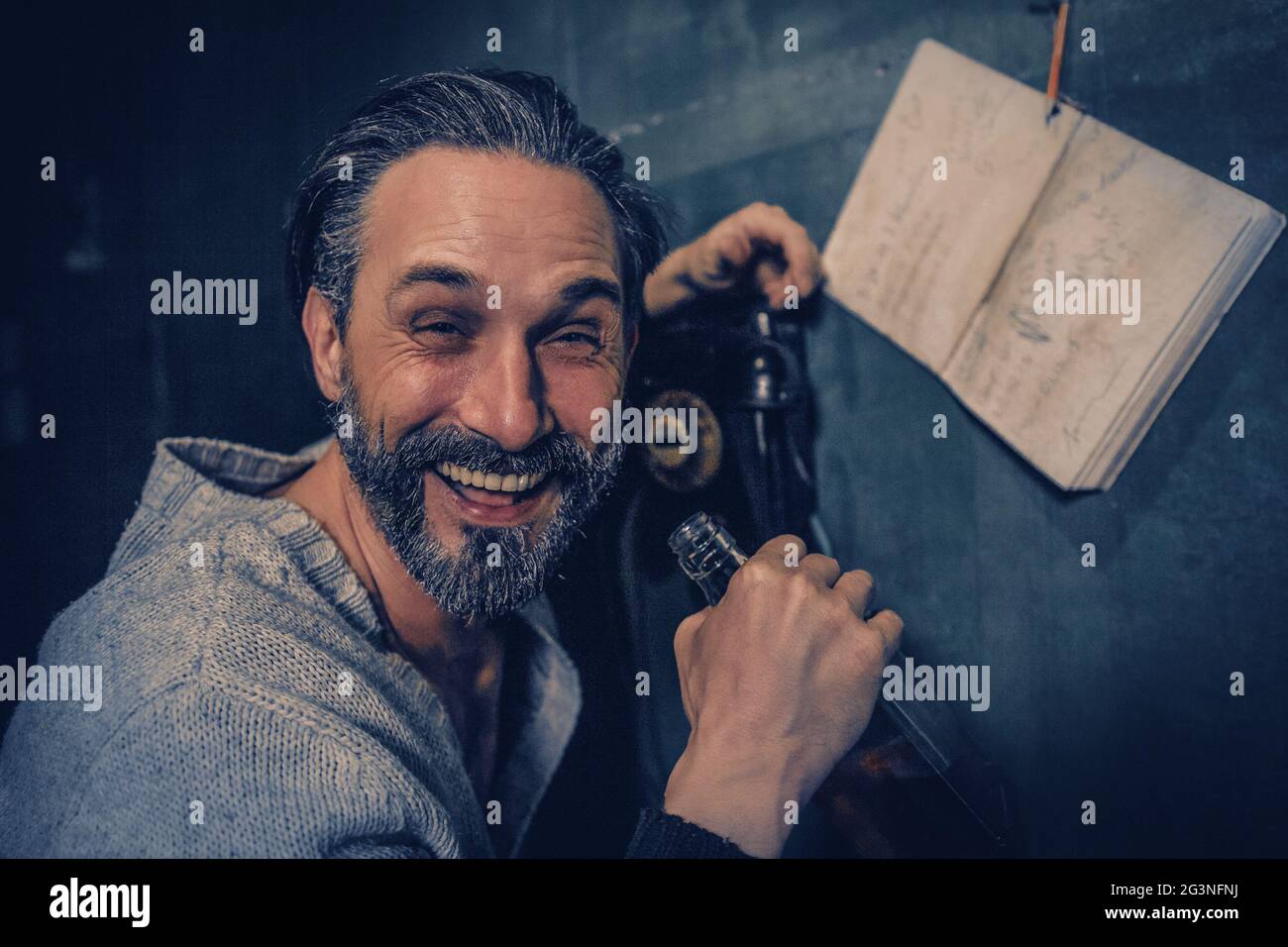 Happy drunk man talks on a vintage rotary telephone Stock Photo - Alamy
