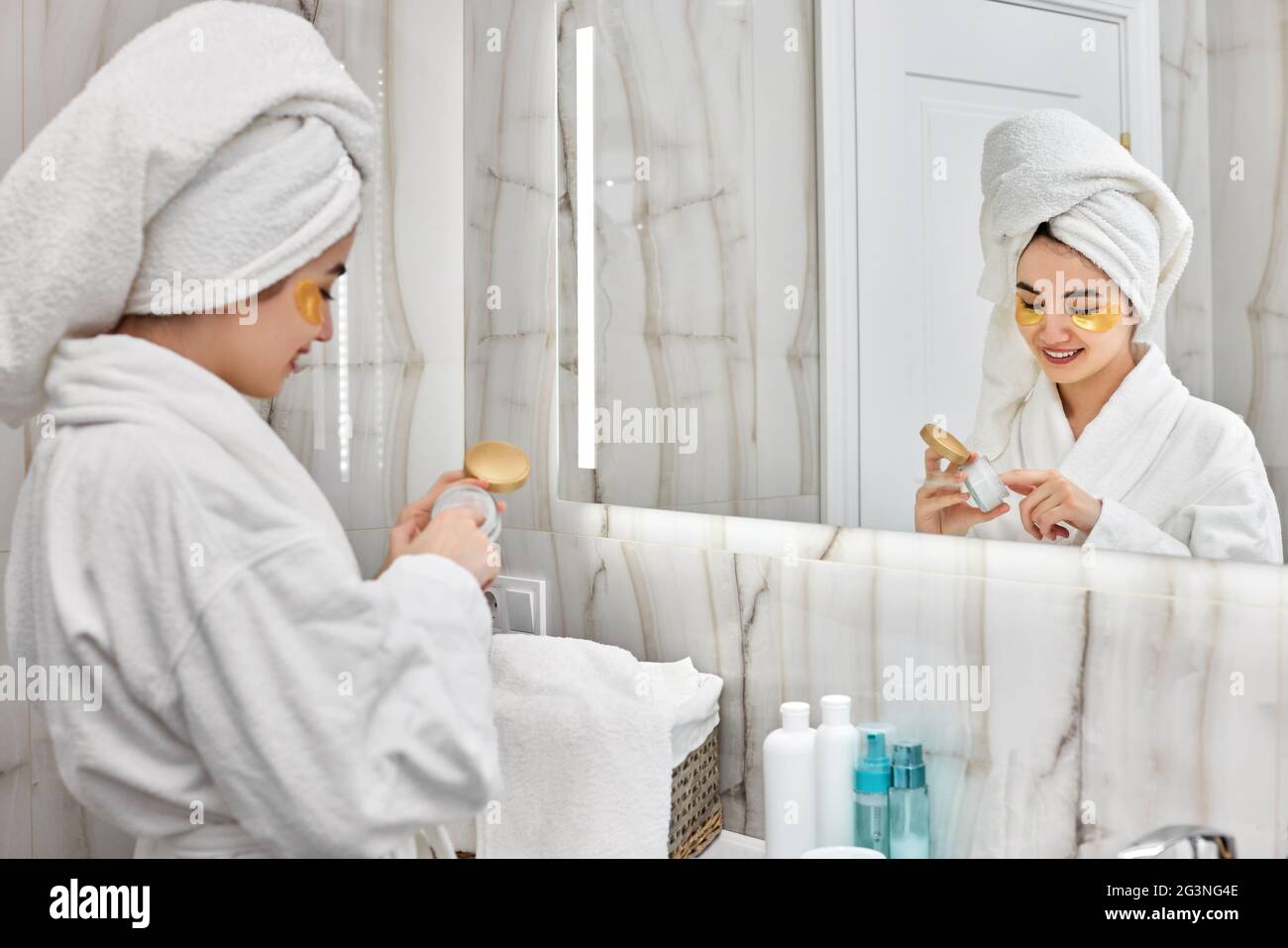Beautiful Woman With Eye Patches In White Bathrobes In Bathroom Stock