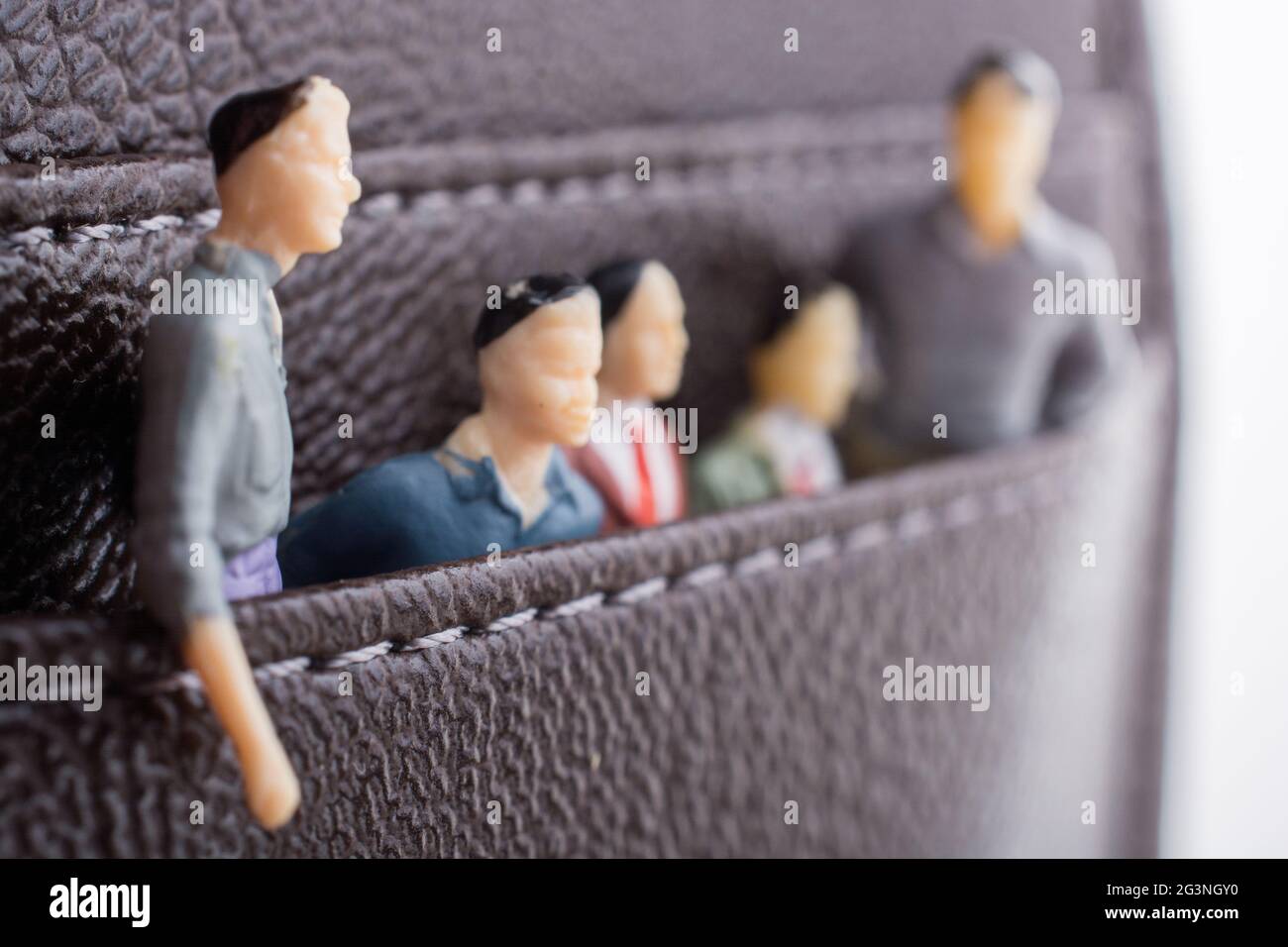Tiny figurine of men model in pockets Stock Photo - Alamy