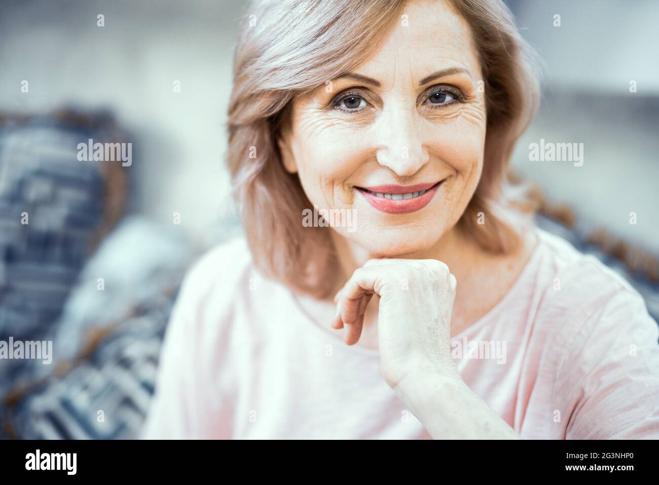 Beautiful mature woman gently smiles at camera Stock Photo - Alamy
