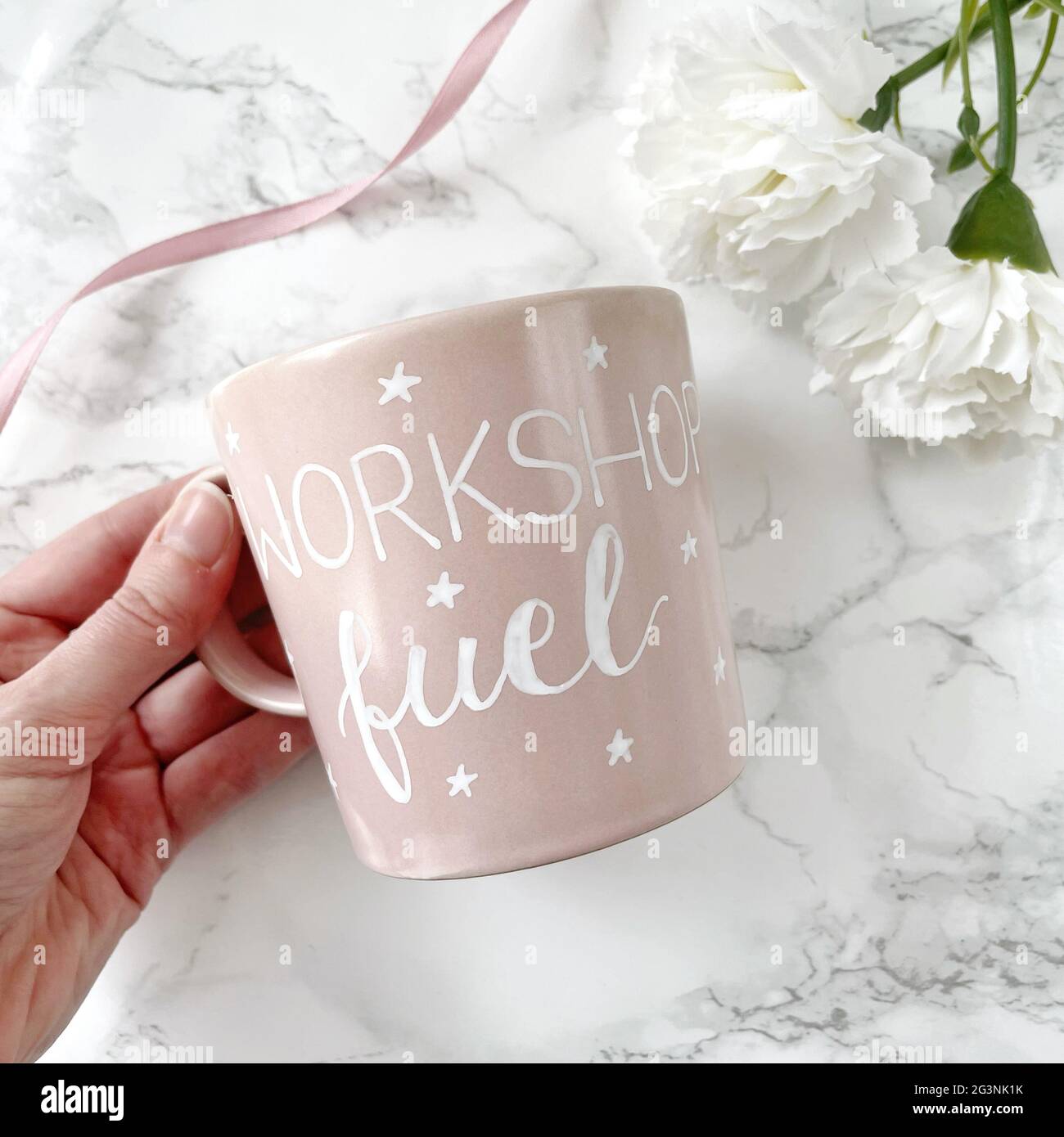 Custom calligraphy project made on pink coffee mug with quote "Workshop ...