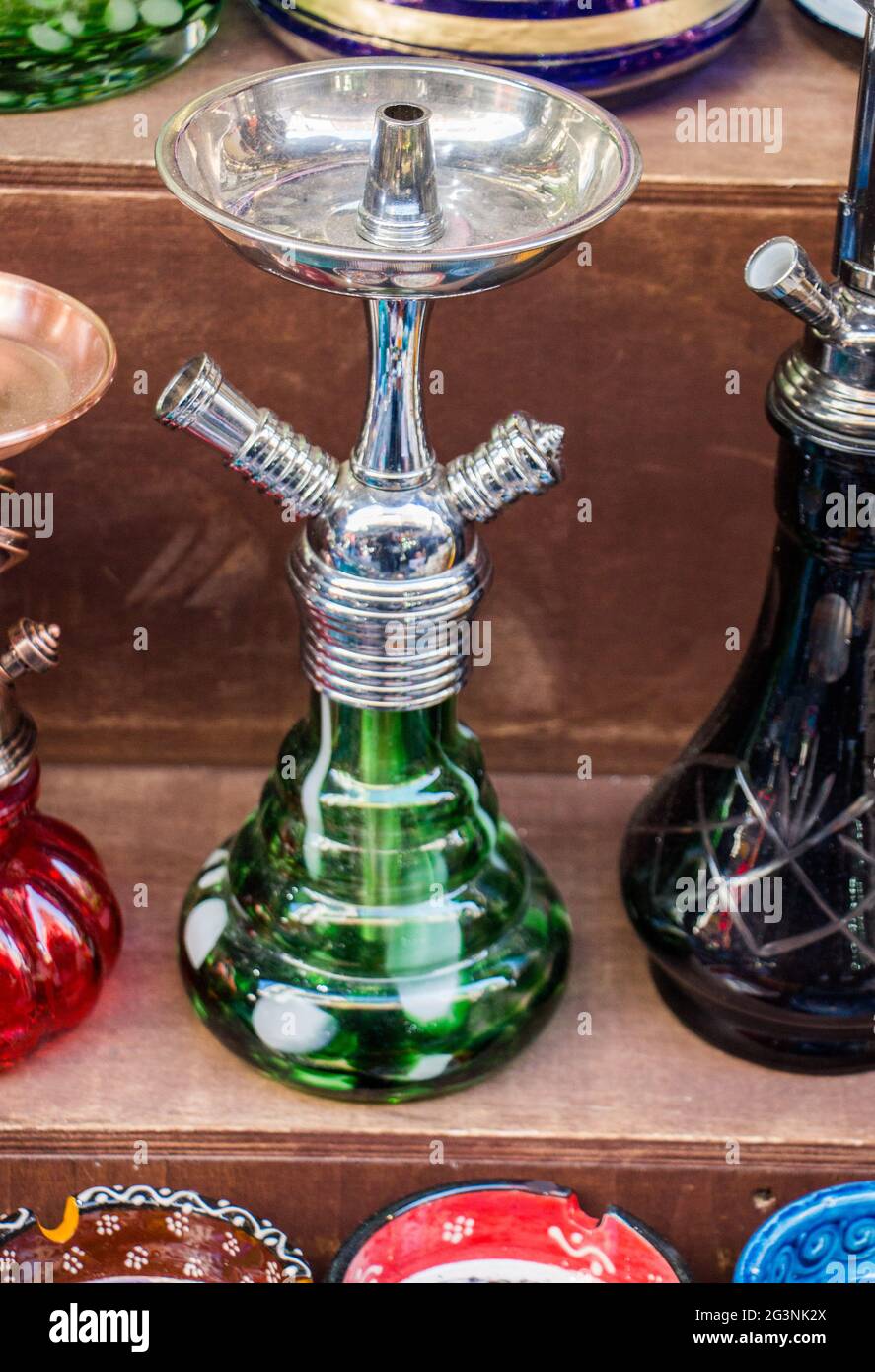 Group of eastern hookahs of various colors on a shelf Stock Photo - Alamy