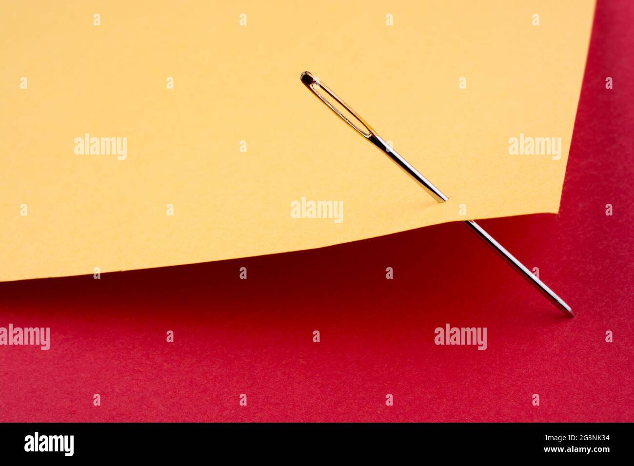 Needle pierced yellow note paper Stock Photo - Alamy