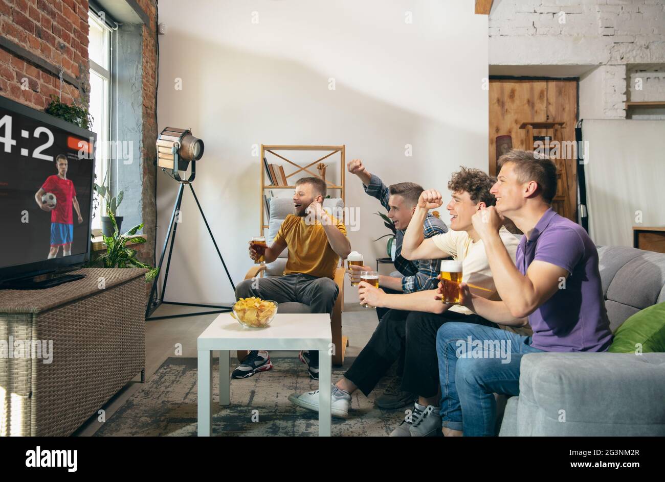 Group of friends watching TV, sport match together. Concept of ...