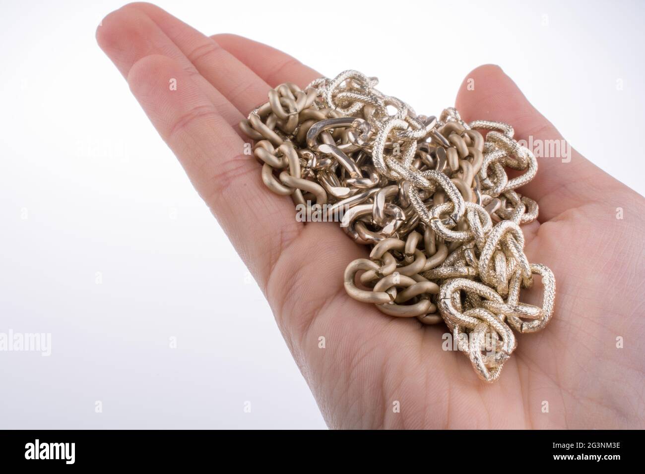 Gold color chain in hand Stock Photo - Alamy