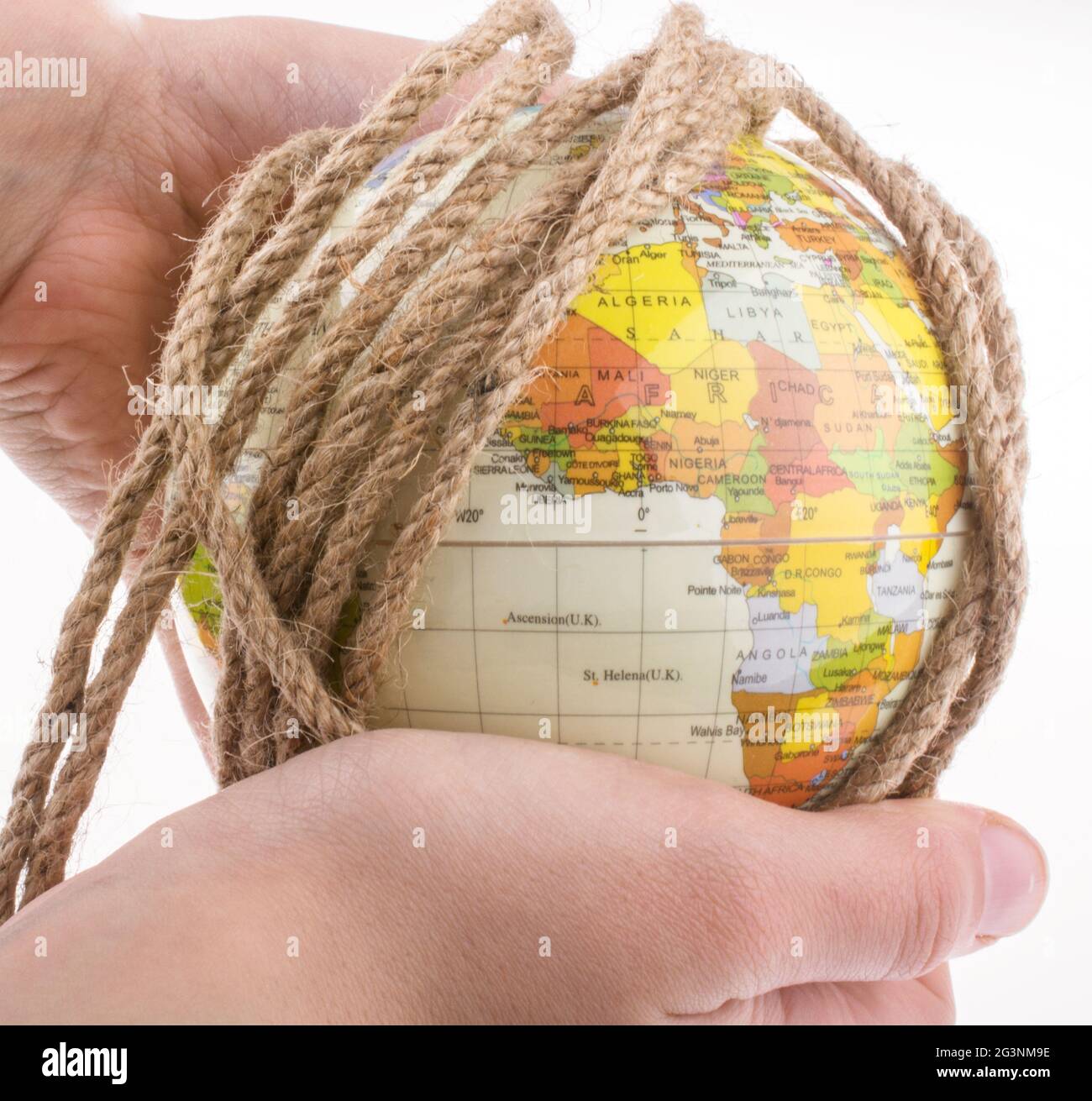 Globe in hand wrapped with rope Stock Photo - Alamy