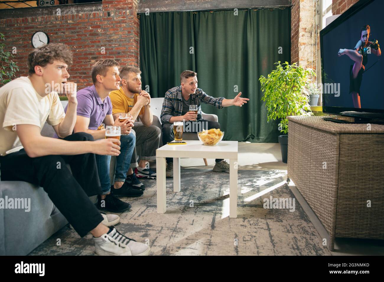 Group of friends watching TV, sport match together. Concept of ...