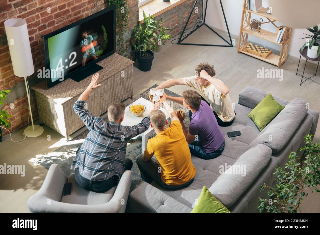 Group of friends watching TV, sport match together. Concept of ...
