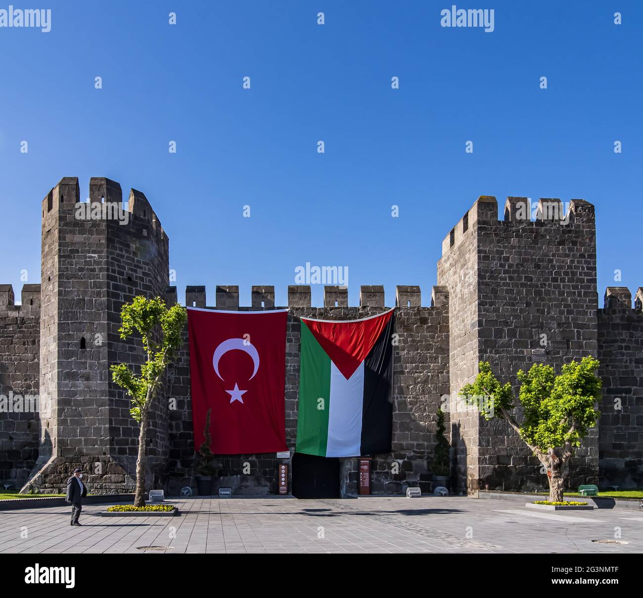 View of an old castle with Palestinian and Turkish flags in Turkey in ...
