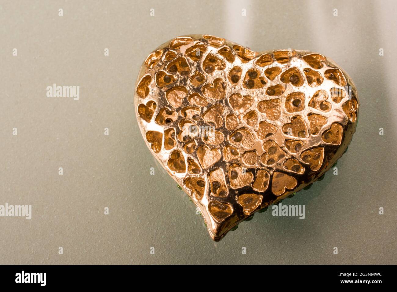 Gold color heart shaped object in view Stock Photo - Alamy
