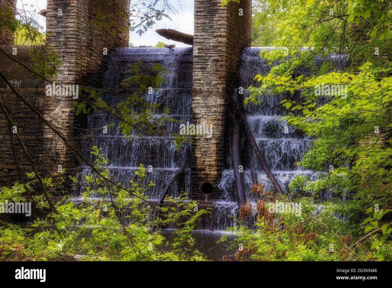water cascades over dam under a stone bridge at Cumberland State Park ...