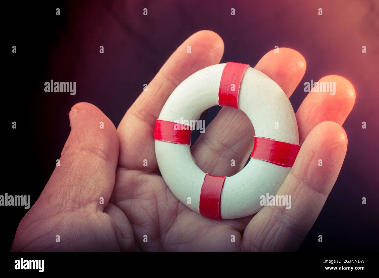 Little model life preserver in hand Stock Photo - Alamy