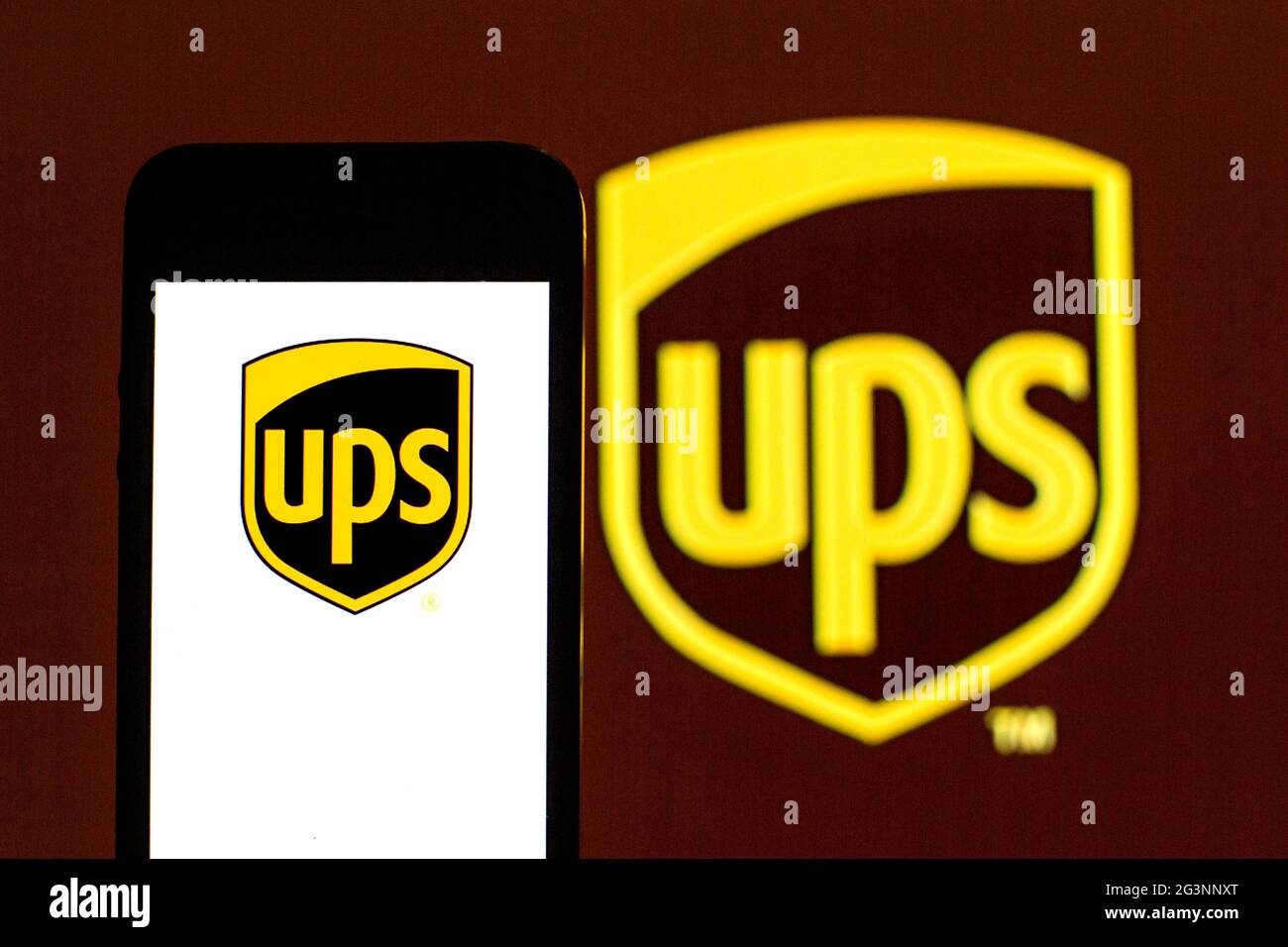 In this photo illustration a United Parcel Service logo seen displayed ...