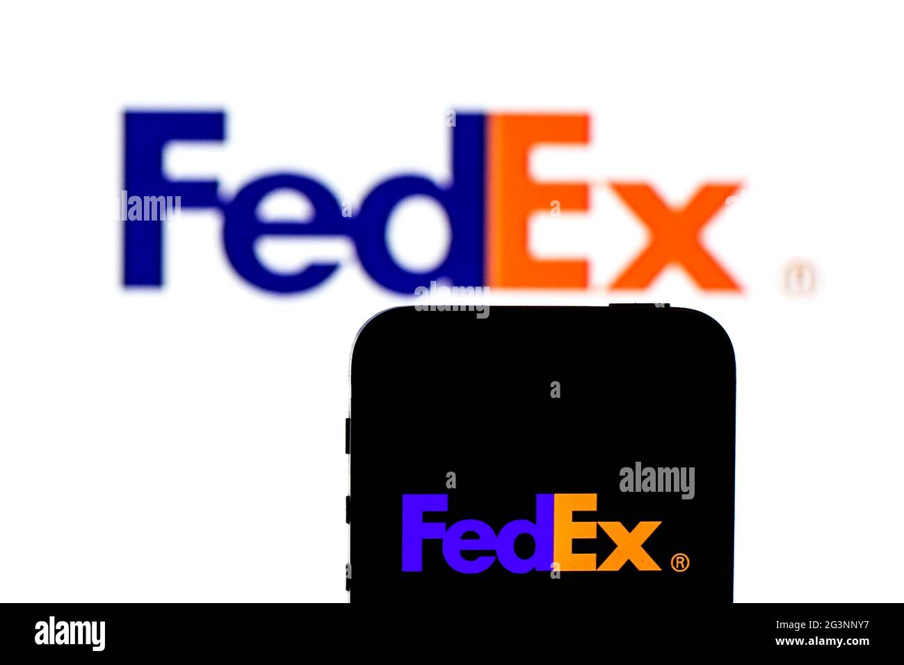 In this photo illustration a FedEx logo seen displayed on a smartphone ...