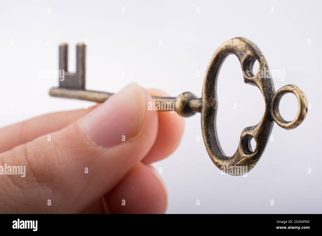 Hand holding key Stock Photo - Alamy