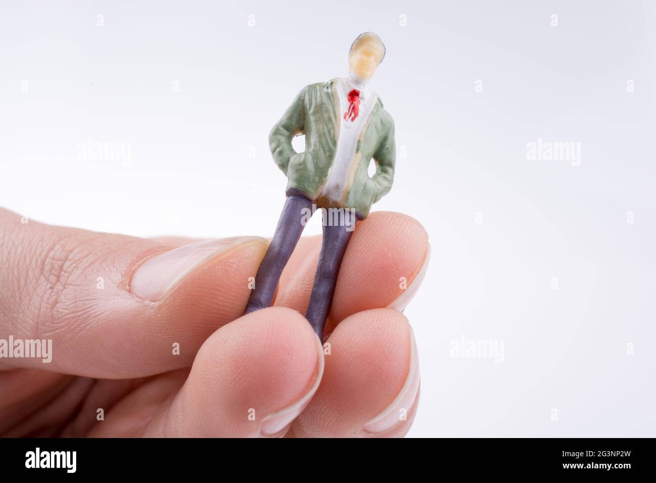 Hand holding a figure Stock Photo - Alamy
