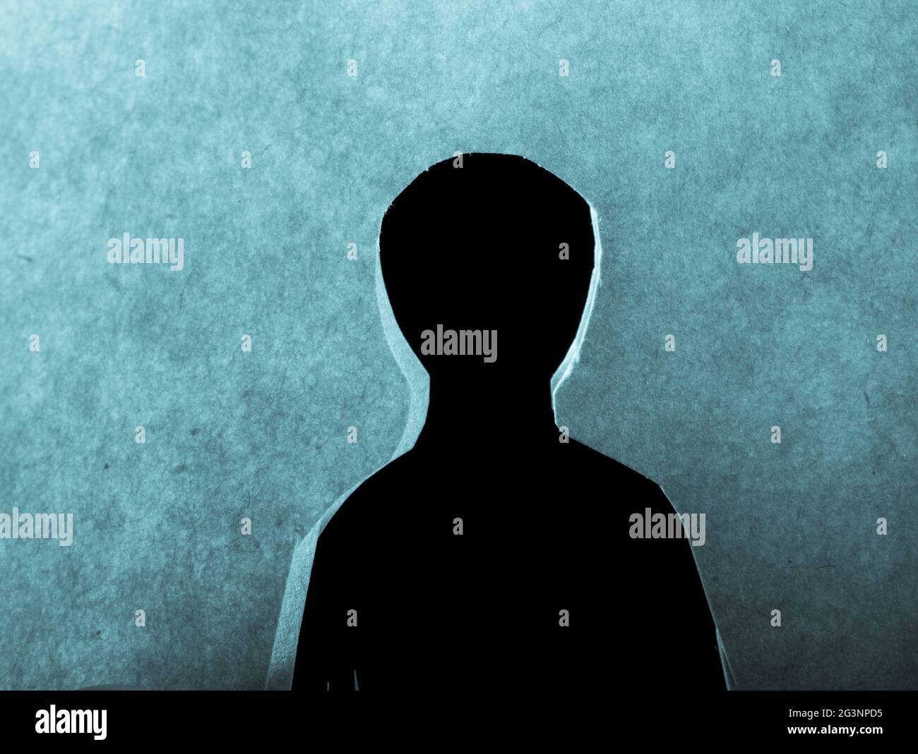 Man shape cut out of paper in hand Stock Photo - Alamy