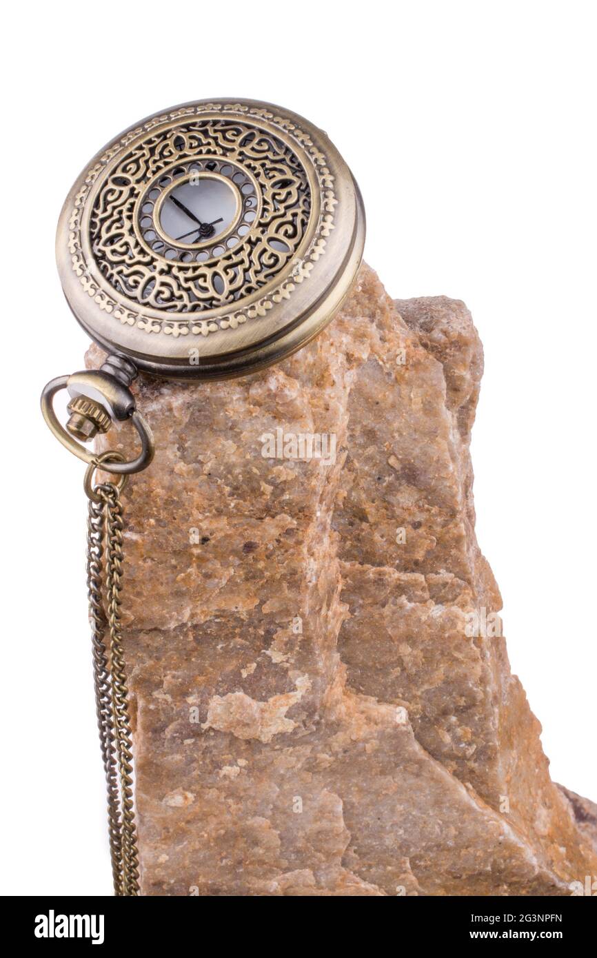 Pocket watch on rock Stock Photo - Alamy
