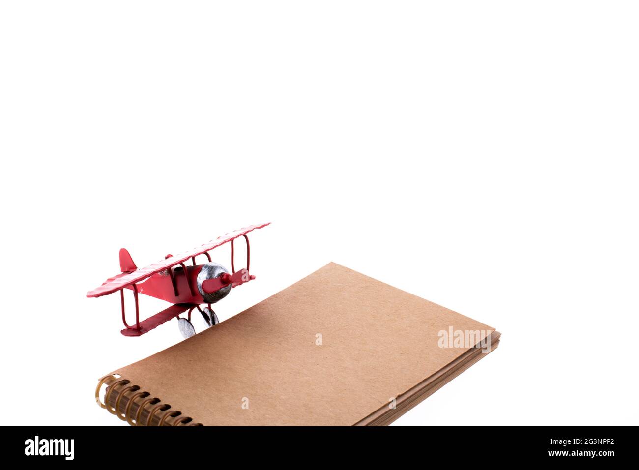 Airplane and notebook Stock Photo - Alamy