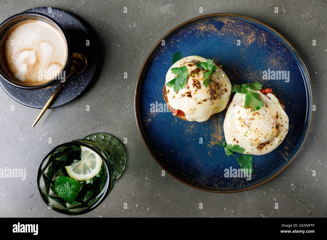 Eggs Benedict with lamb and tomato salsa Stock Photo - Alamy