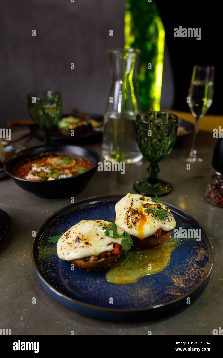 Eggs Benedict with lamb and tomato salsa Stock Photo - Alamy