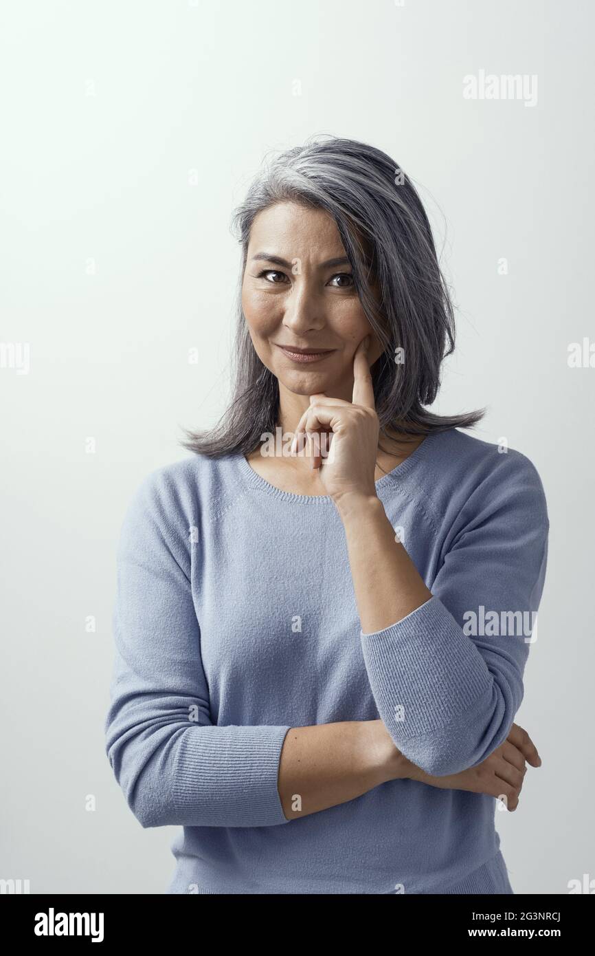 Beautiful woman pointing cheek hi-res stock photography and images - Alamy