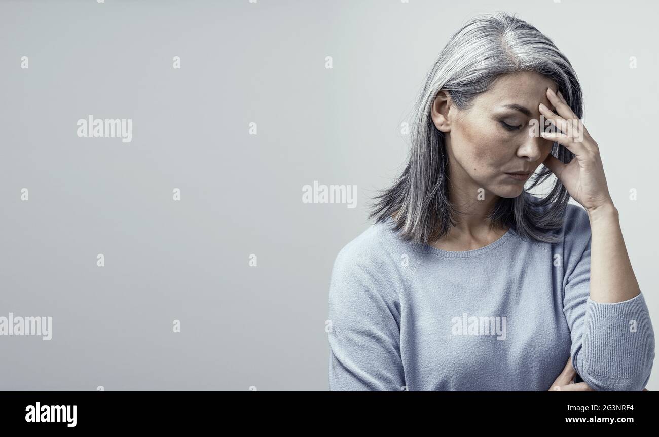 Asian woman in distress on white background Stock Photo - Alamy