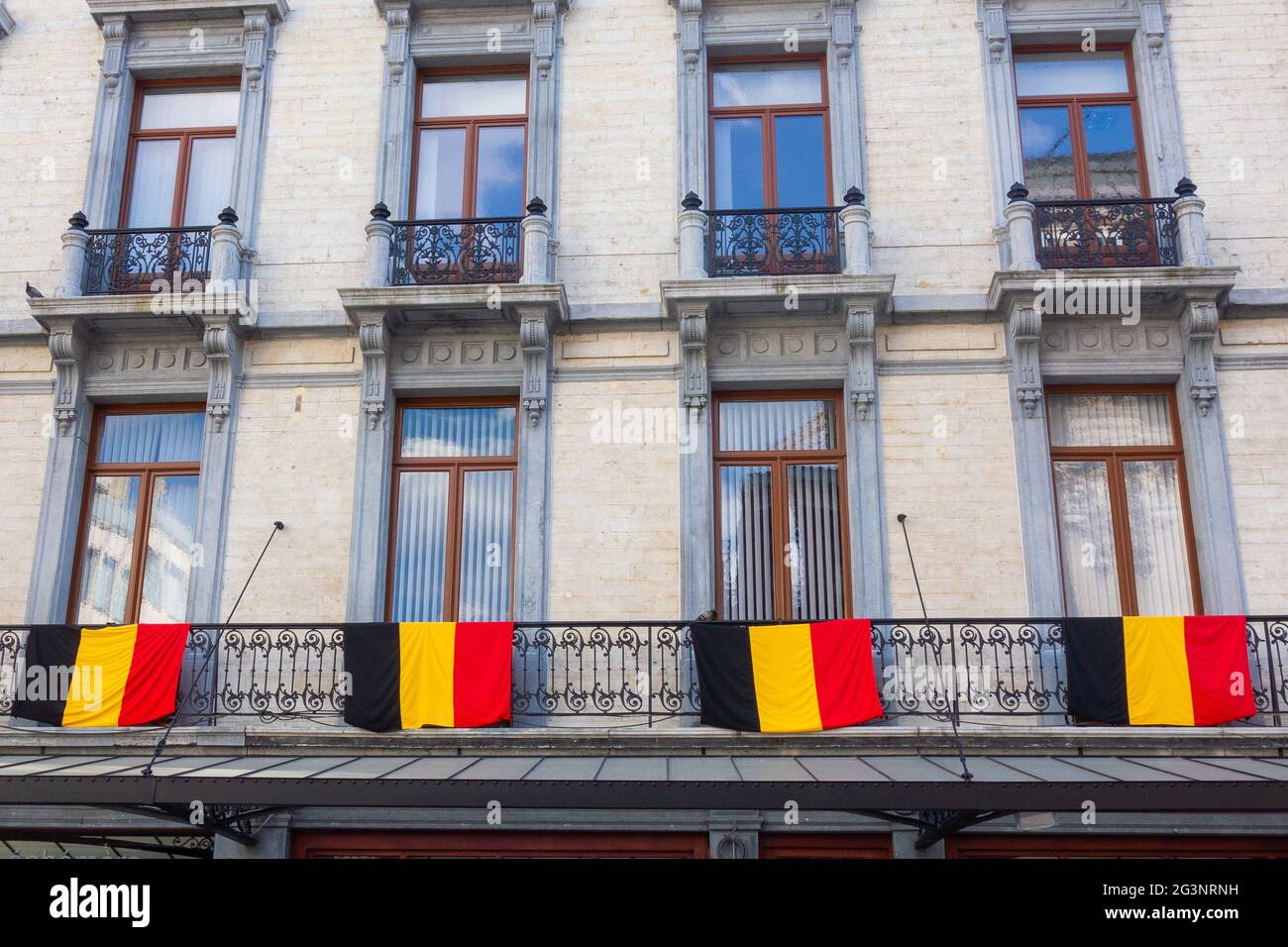 Brussels, Belgium, June 16, 2021. Belgian flag on the balcony of houses ...