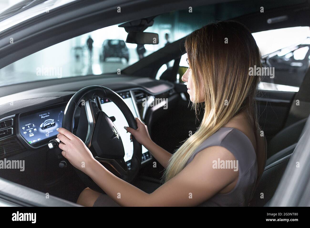 Tesla New-generation Electric Car of Dark Brown Indoor Stock Photo - Alamy