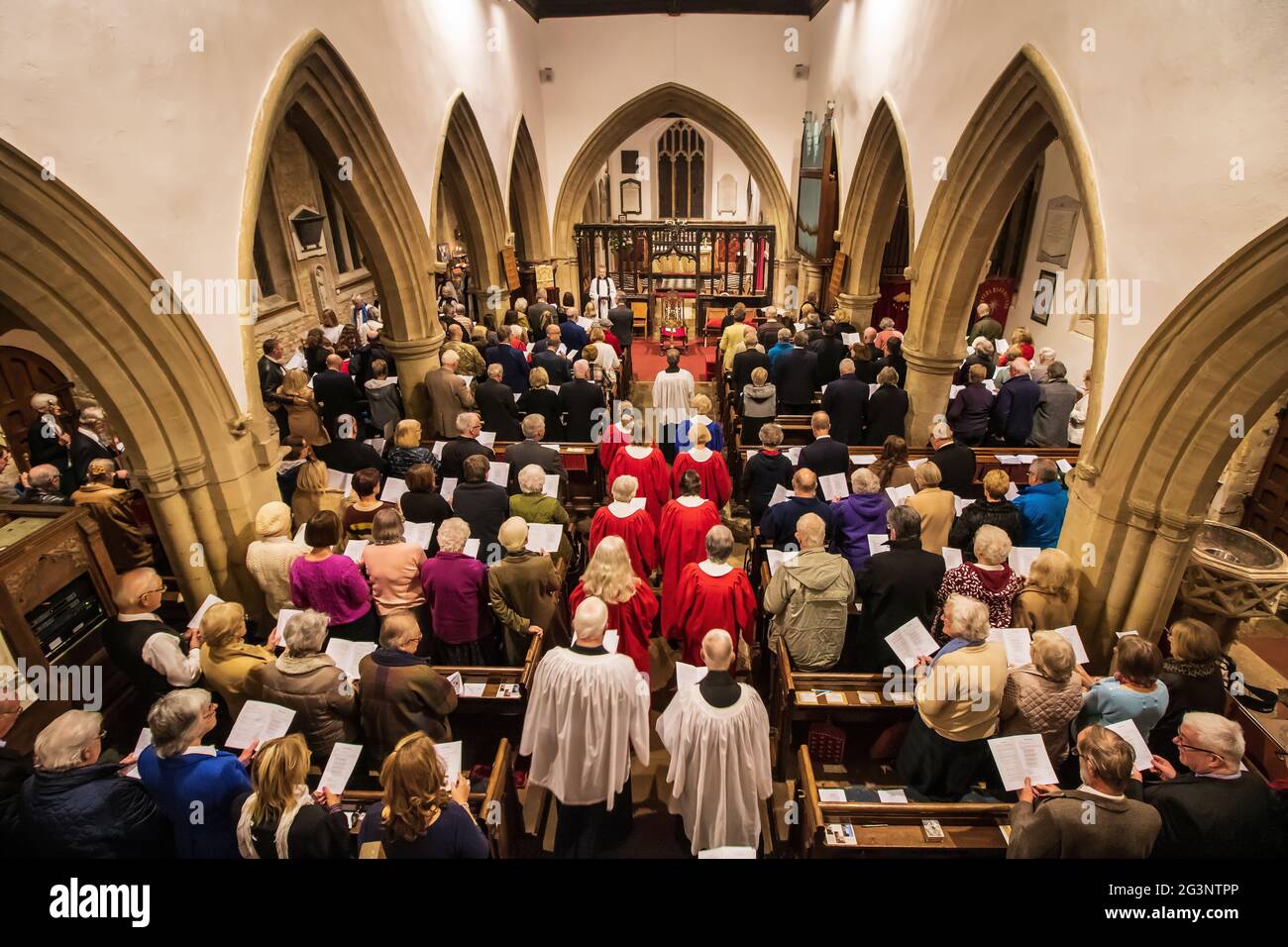 Procession of choir and clergy past congregation at parish church ...