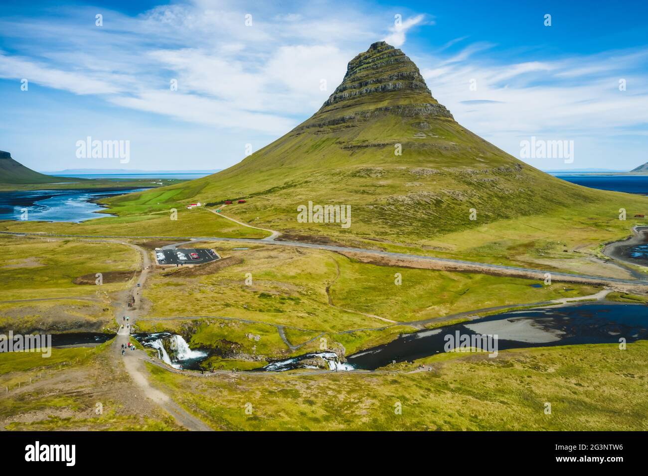 Aerial view of Kirkjufell mountain landscape and waterfalls below in ...