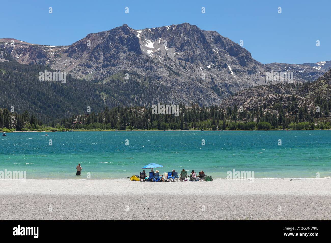 JUNE LAKE, CALIFORNIA, UNITED STATES - Jun 16, 2021: A family sits in ...