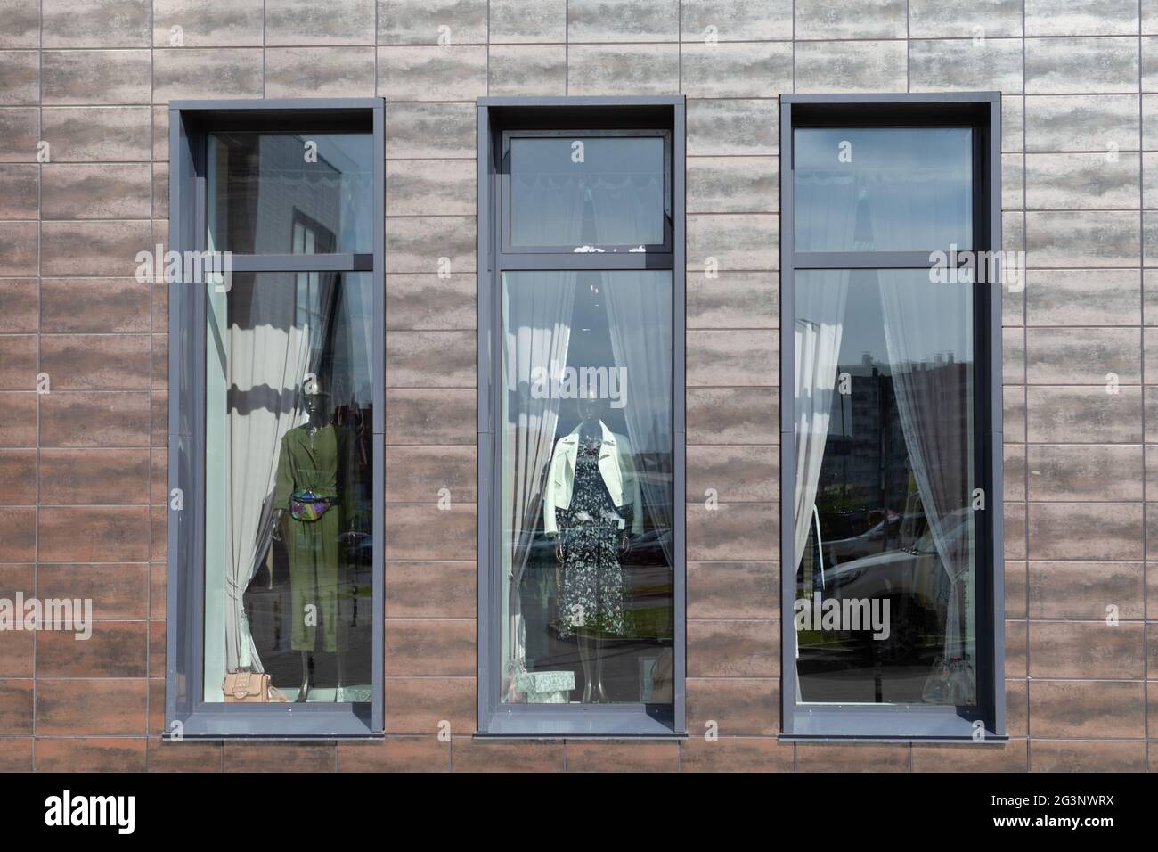The windows of the store, which are mannequins in fashionable clothes ...
